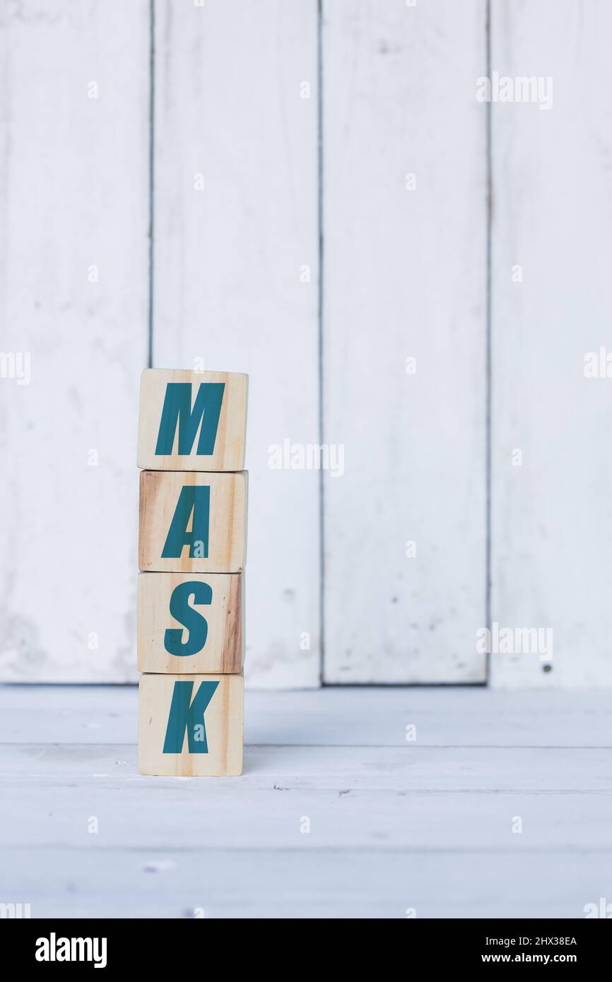 mask word or concept on wooden blocks, white wood background Stock ...