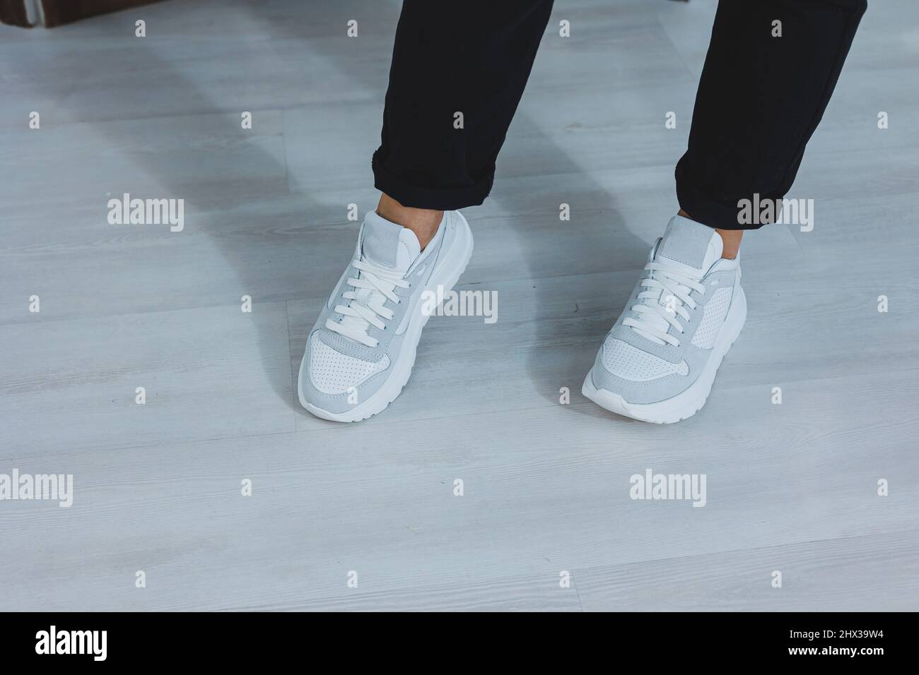 Beautiful women's shoes with legs, leather white sneakers, in the ...