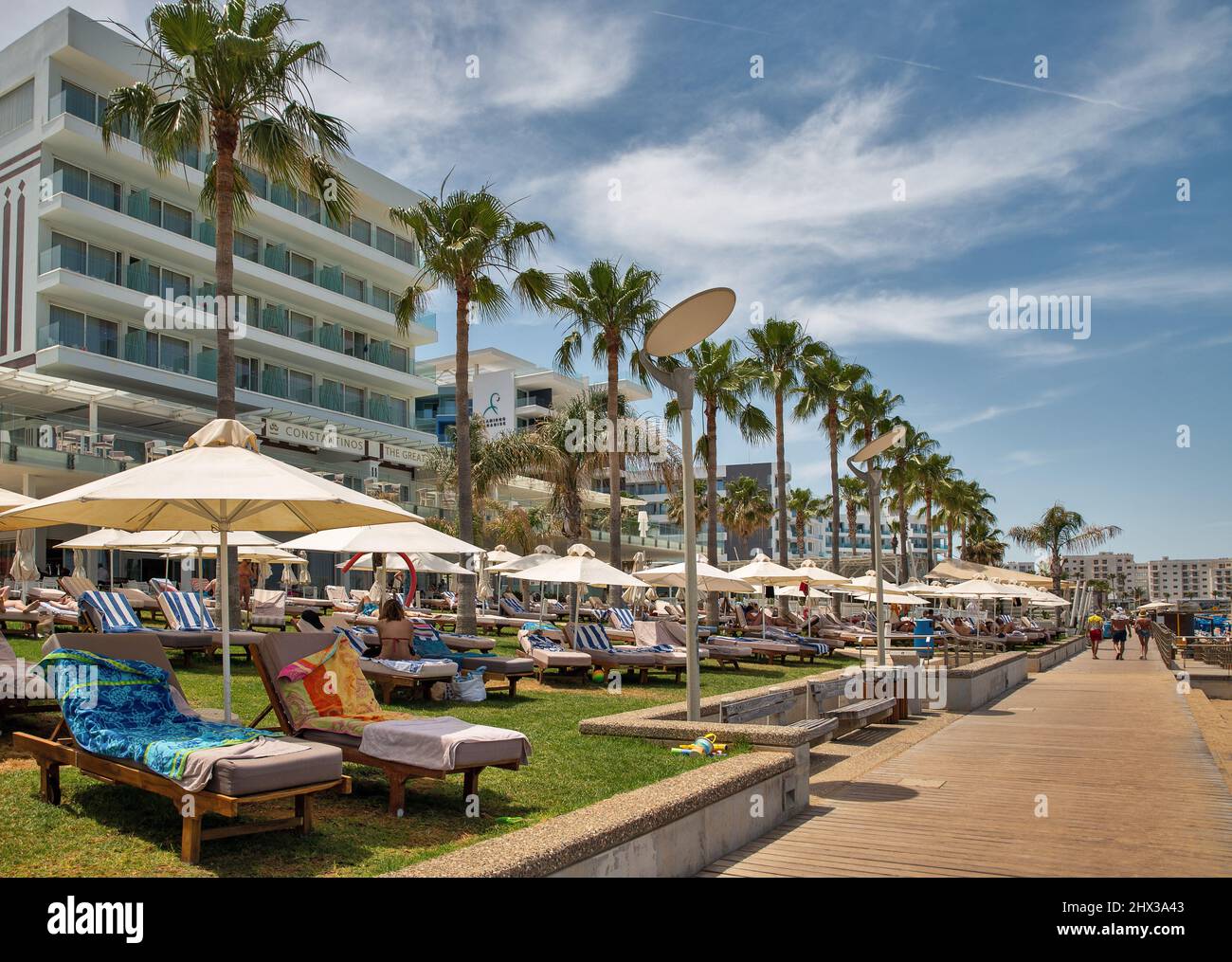 Protaras, Cyprus - May 25, 2021: People walk along resort seafront with ...
