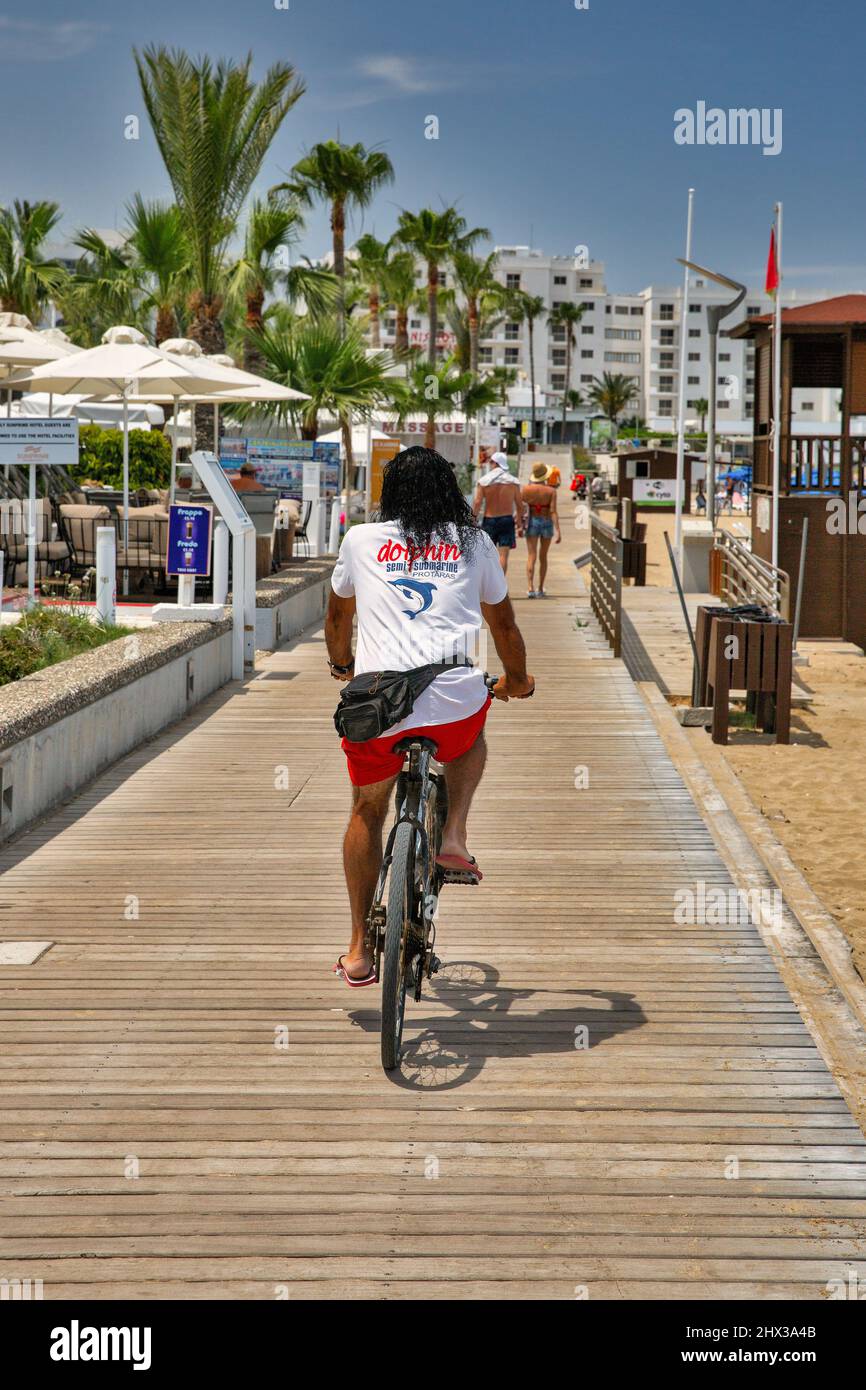 Protaras, Cyprus - May 25, 2021: People walk along seafront promenade ...