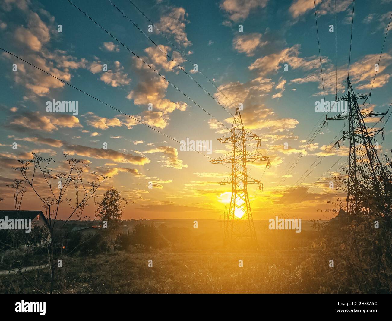 High voltage power lines. Sunset background. High voltage tower Stock ...