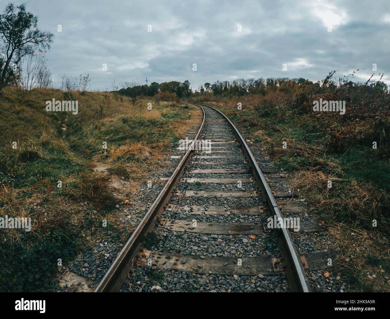 Railway track turn. Iron train rails in countryside Stock Photo - Alamy