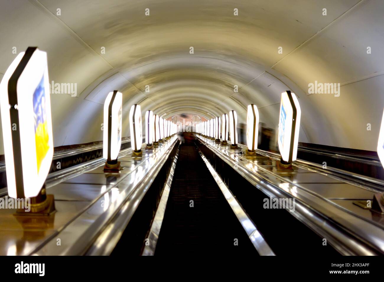 The descent on the escalator in the underground metro.Toning. People ...