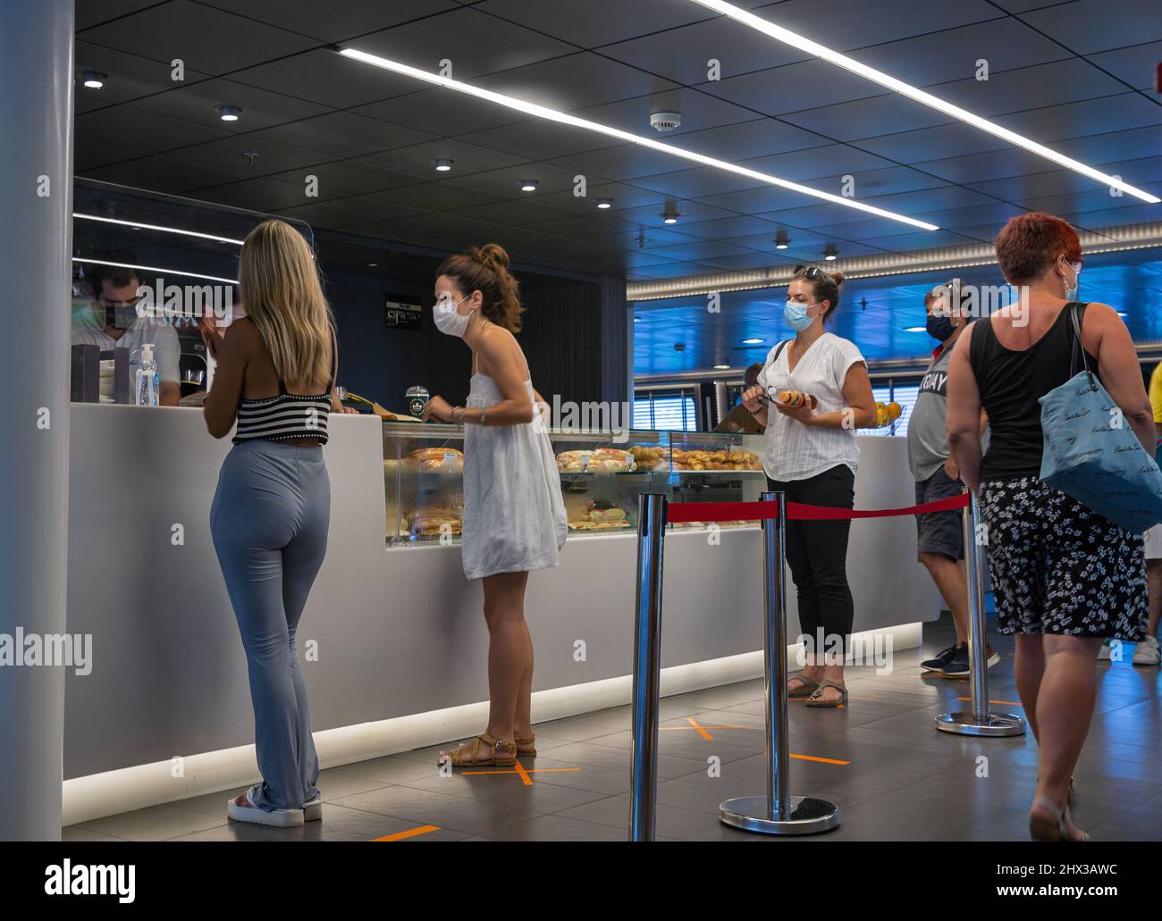 Igoumenitsa, Greece - August 10, 2021: People queue for a buffet in the ...