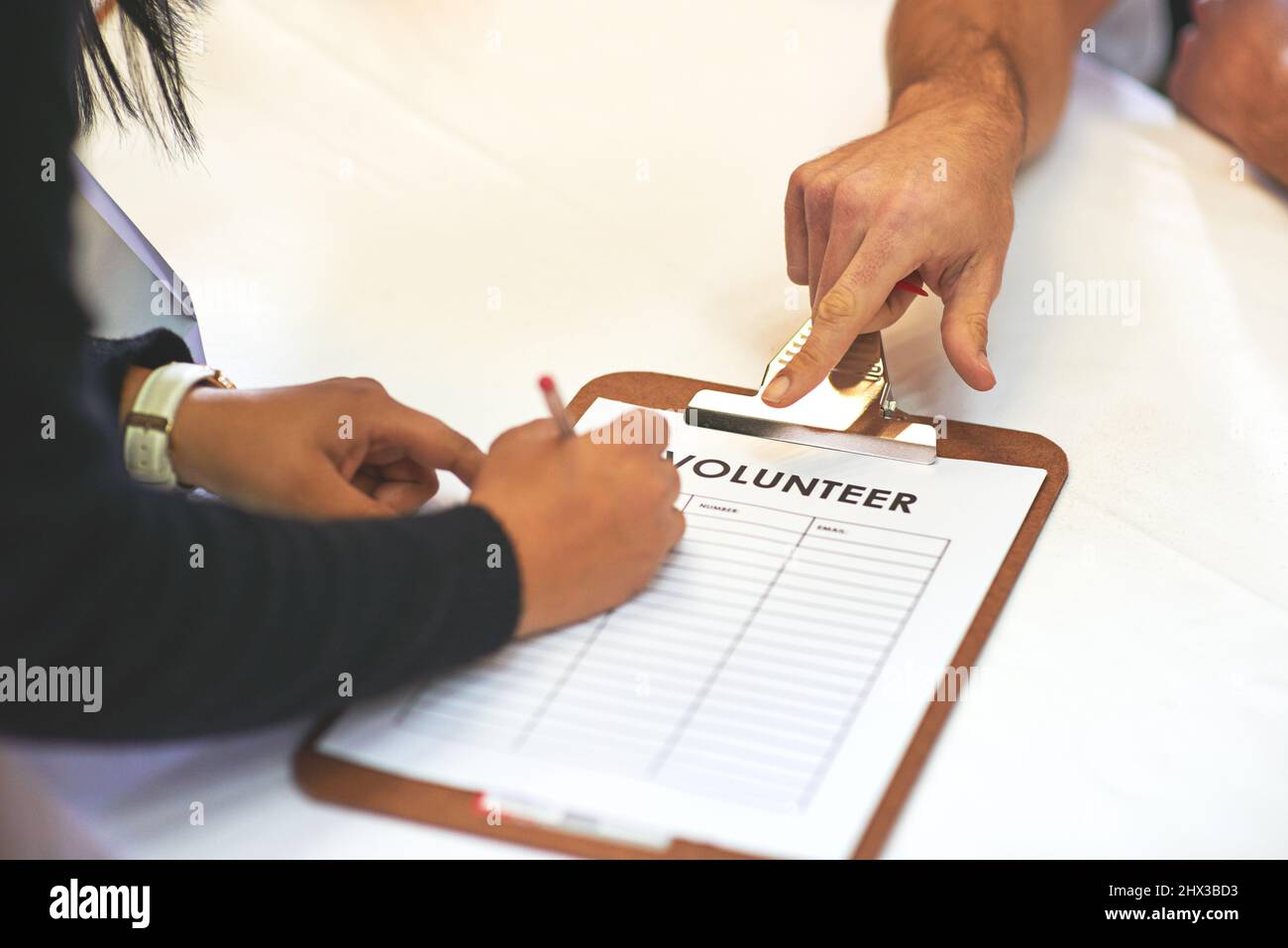 Every little bit helps. Cropped shot of volunteer getting signatures ...