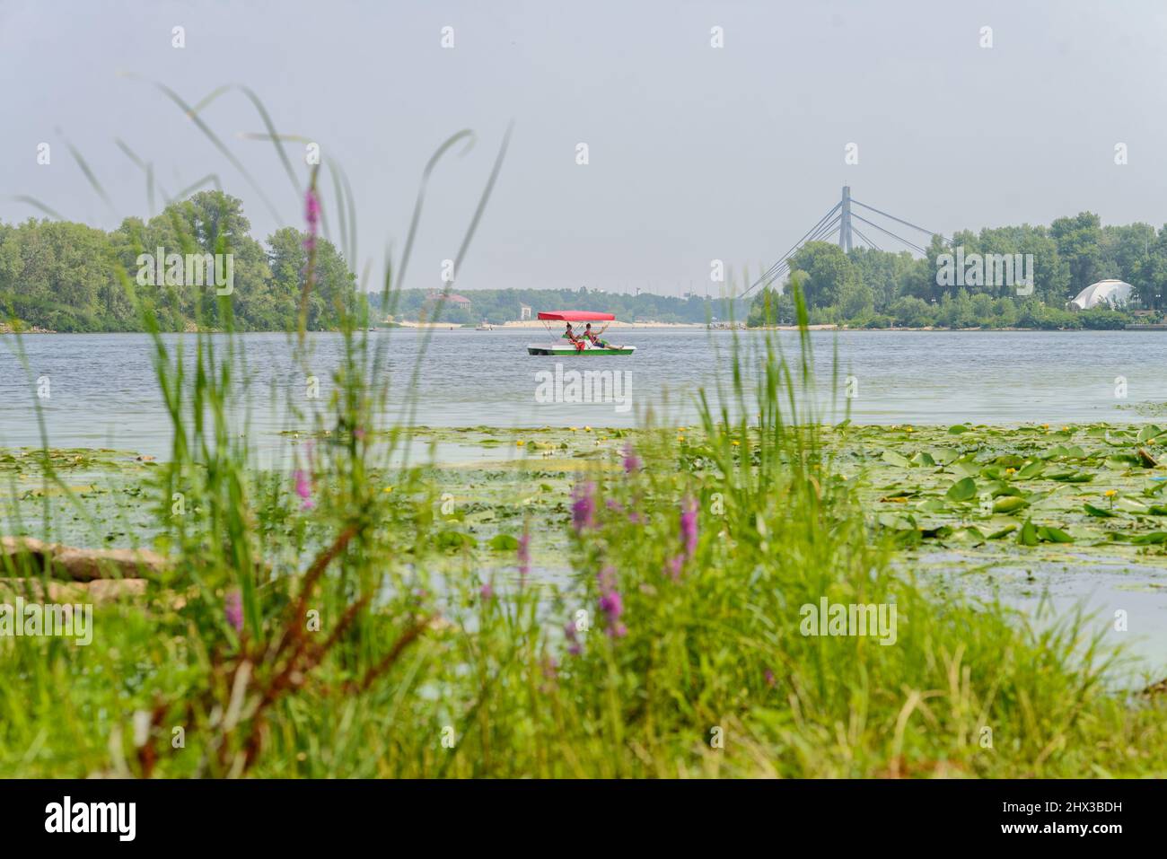 Couple floating on the river on a catamaran Stock Photo - Alamy