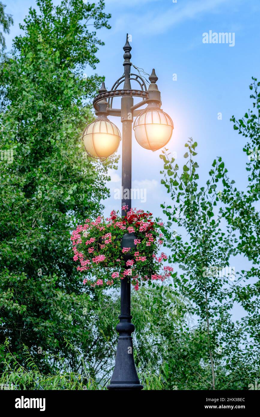 Street lamp with flowers Vases.Toning Stock Photo - Alamy