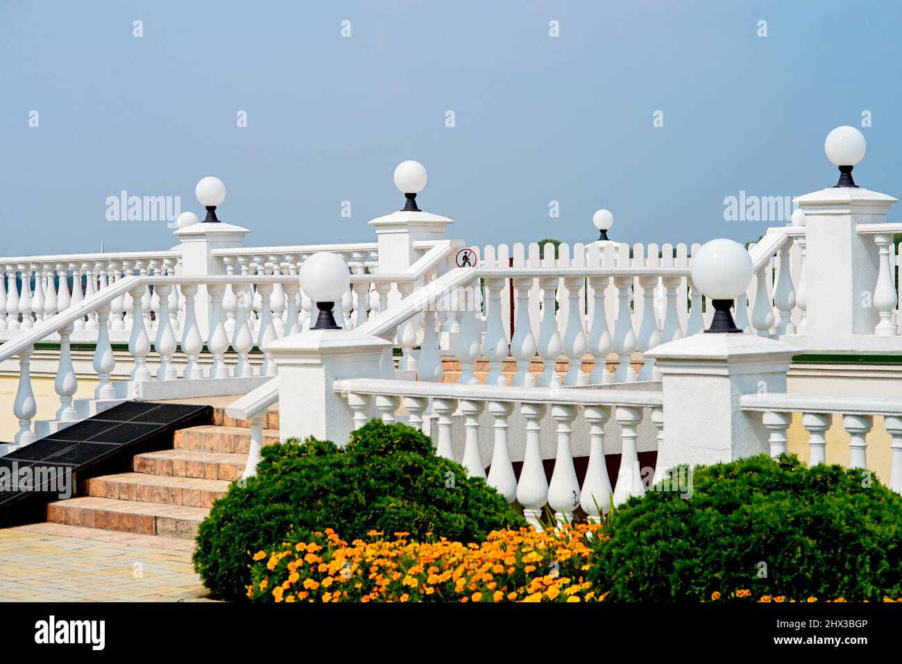 Balcony with white columns, round lamps and stone staircase Stock Photo ...