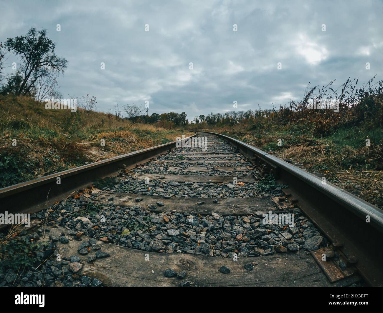 Railway track turn. Iron train rails in countryside Stock Photo - Alamy