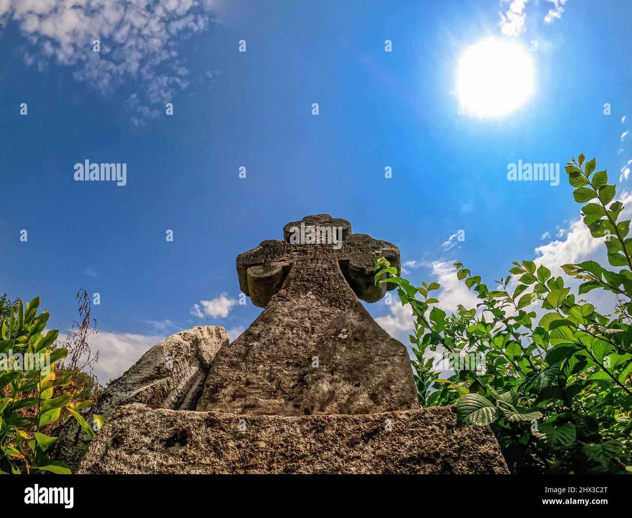 Medieval cross monument with carved inscription. Ancient stone cross ...