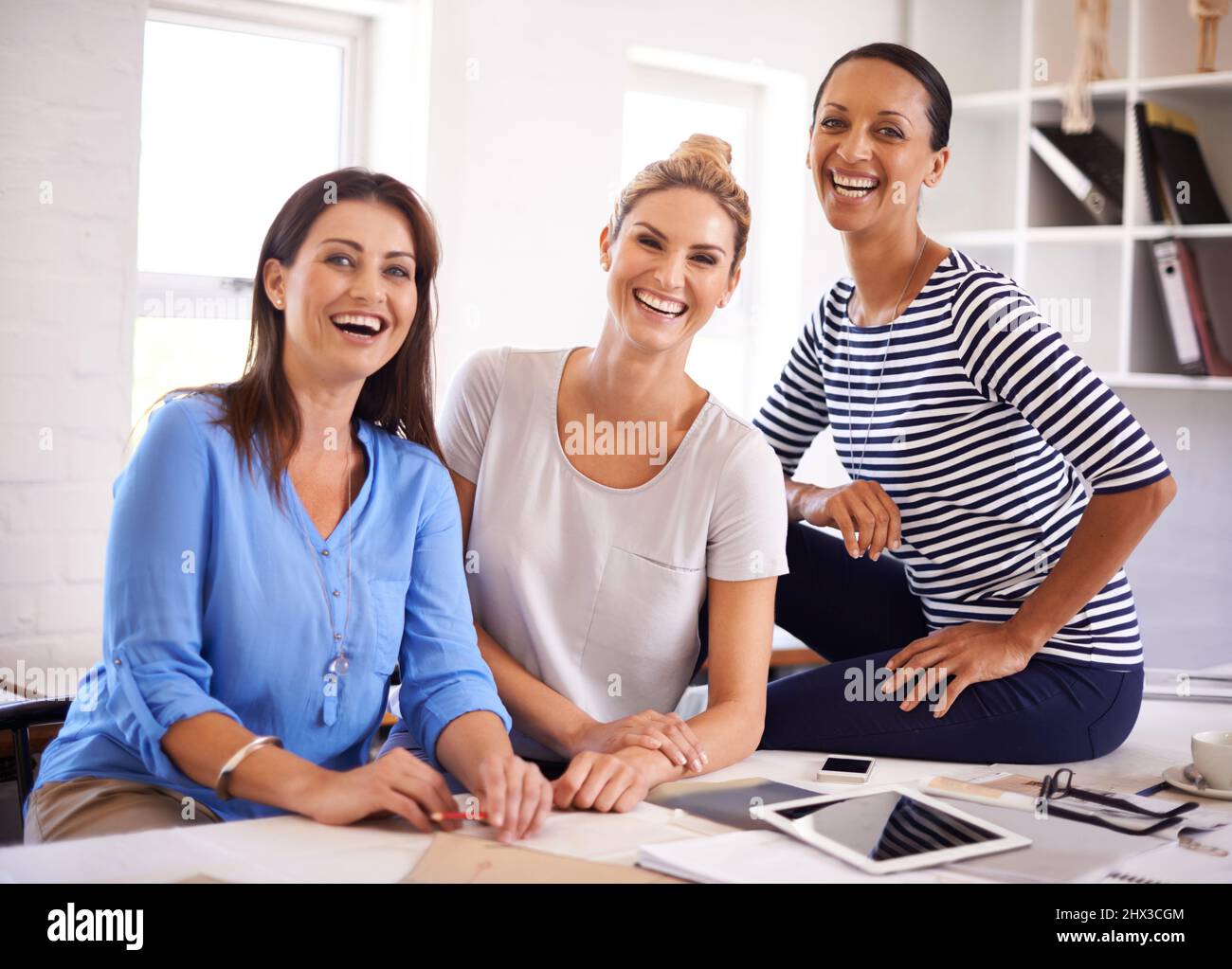 Working towards a common vision. Three confident young businesswomen ...