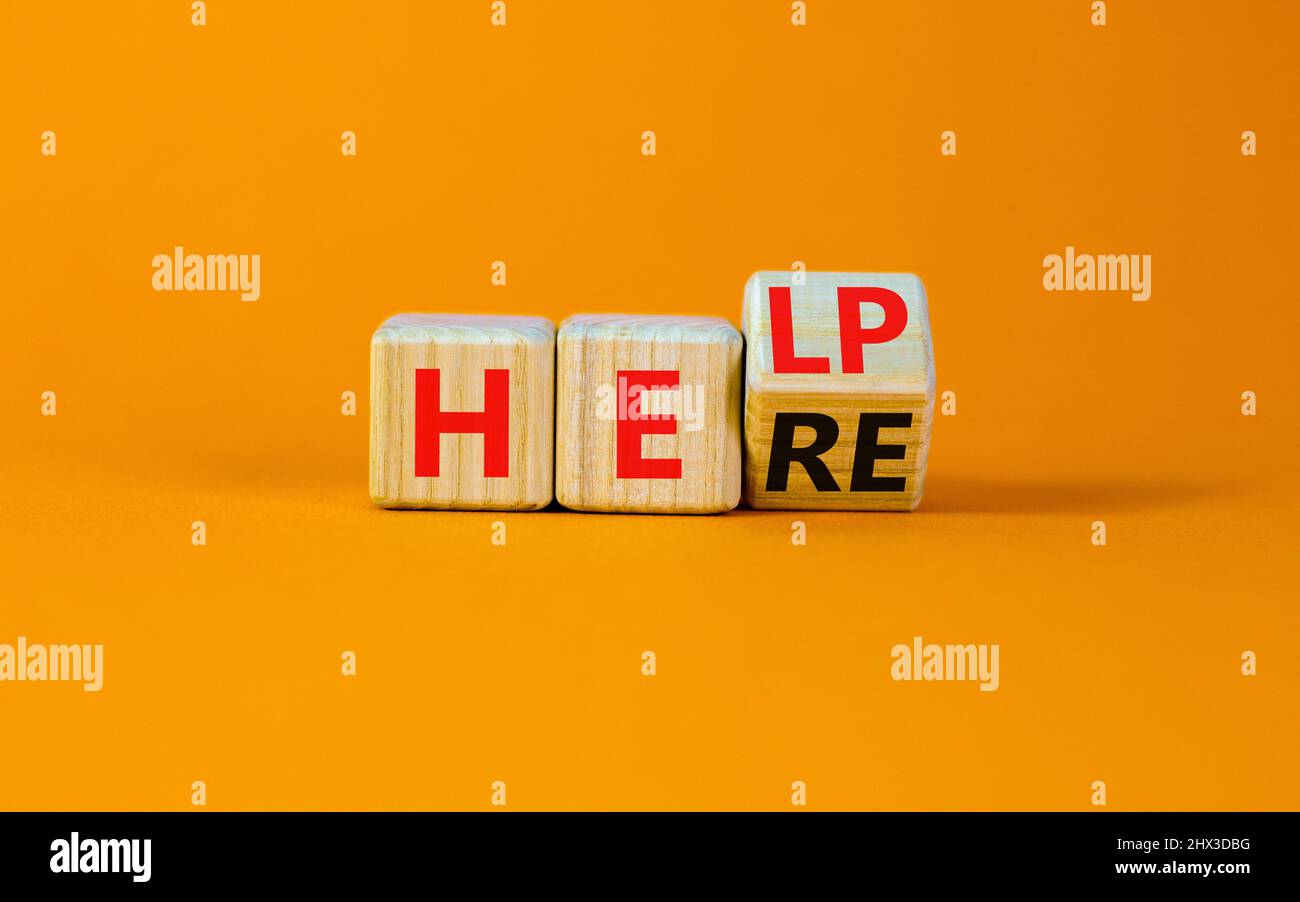 Help is here support symbol. Turned a wooden cube with concept word ...