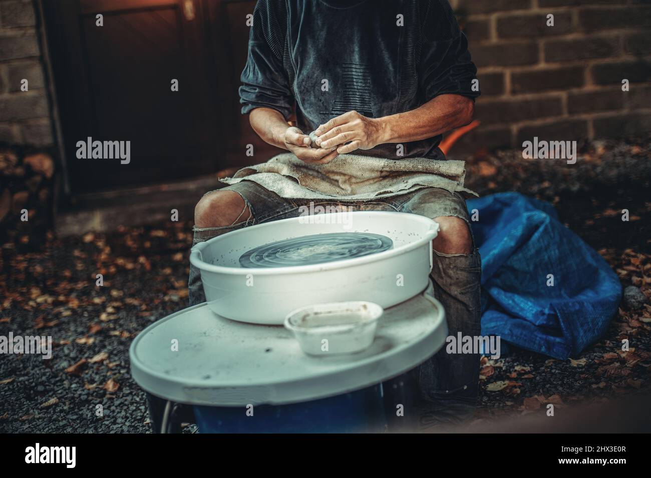 Potter wheel and potter hands, skilled hands of potter shaping the clay ...