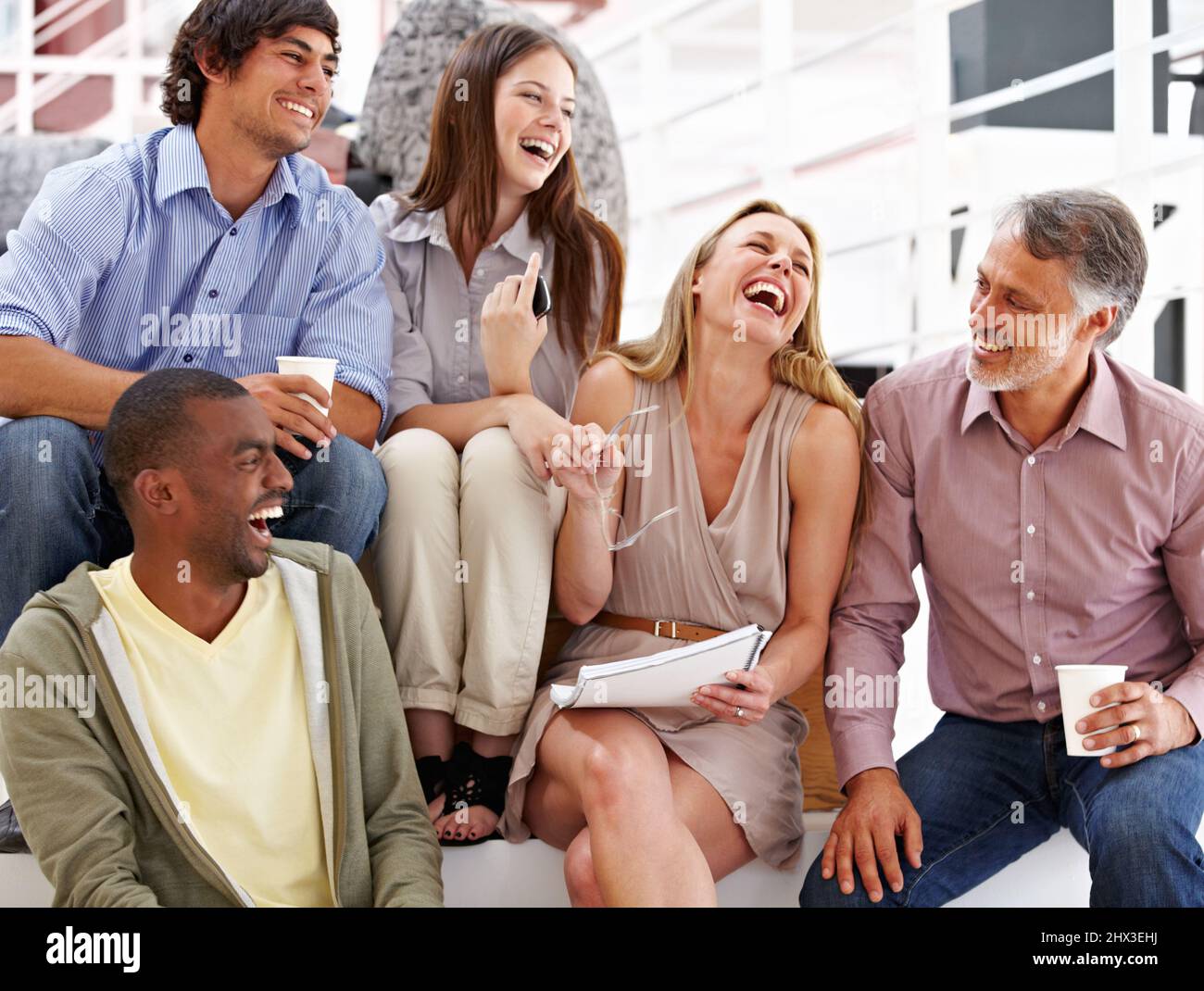 Working with a great team. A team of designers laughing at their ...