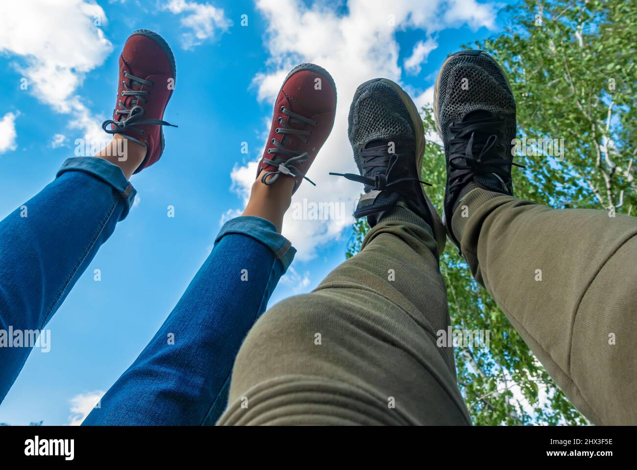 Feet in the sky. Man and woman with raised legs against the sky Stock ...