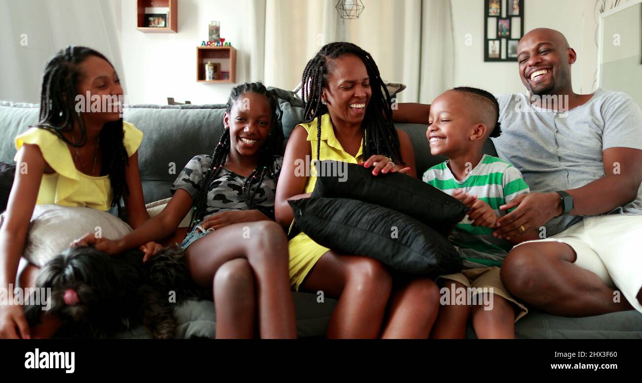 African family together at home couch. Black ethnicity parents and ...