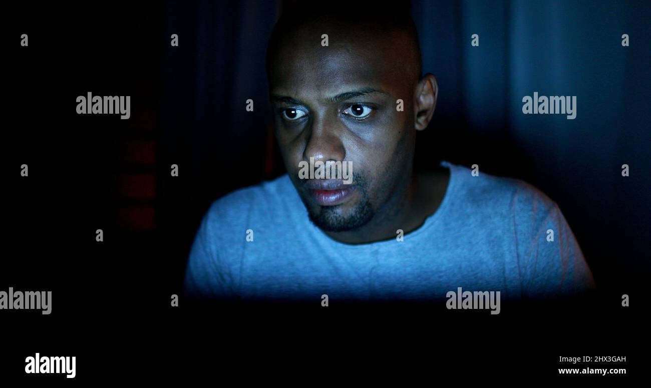 Black man face staring at laptop screen at night Stock Photo - Alamy