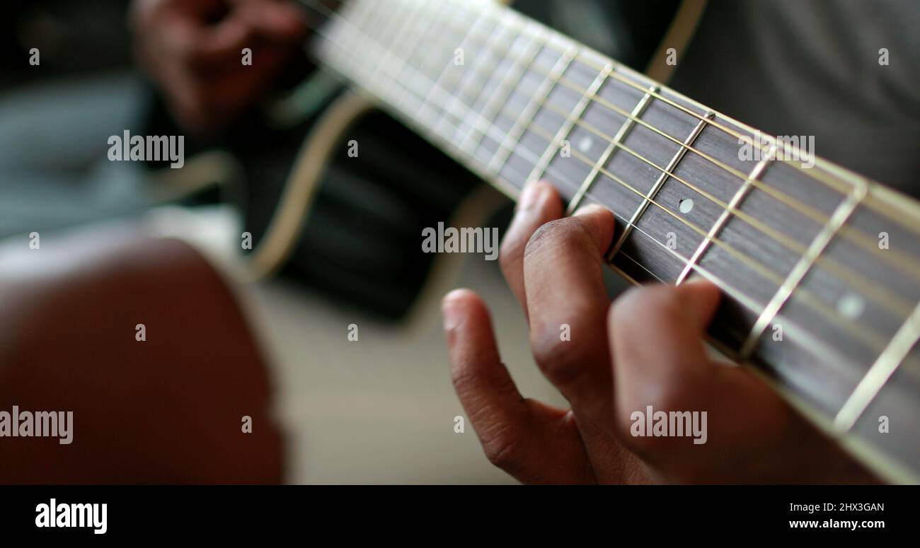 Black man hands playing guitar. African person practicing with musical ...