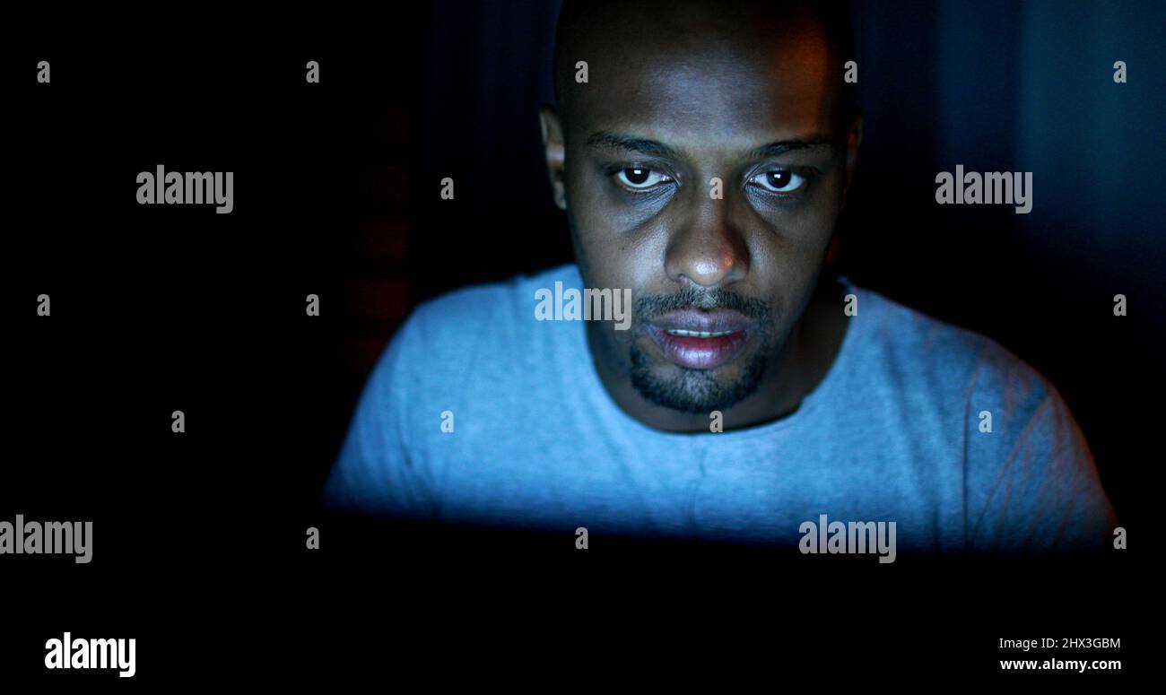 Black man face staring at laptop screen at night Stock Photo - Alamy