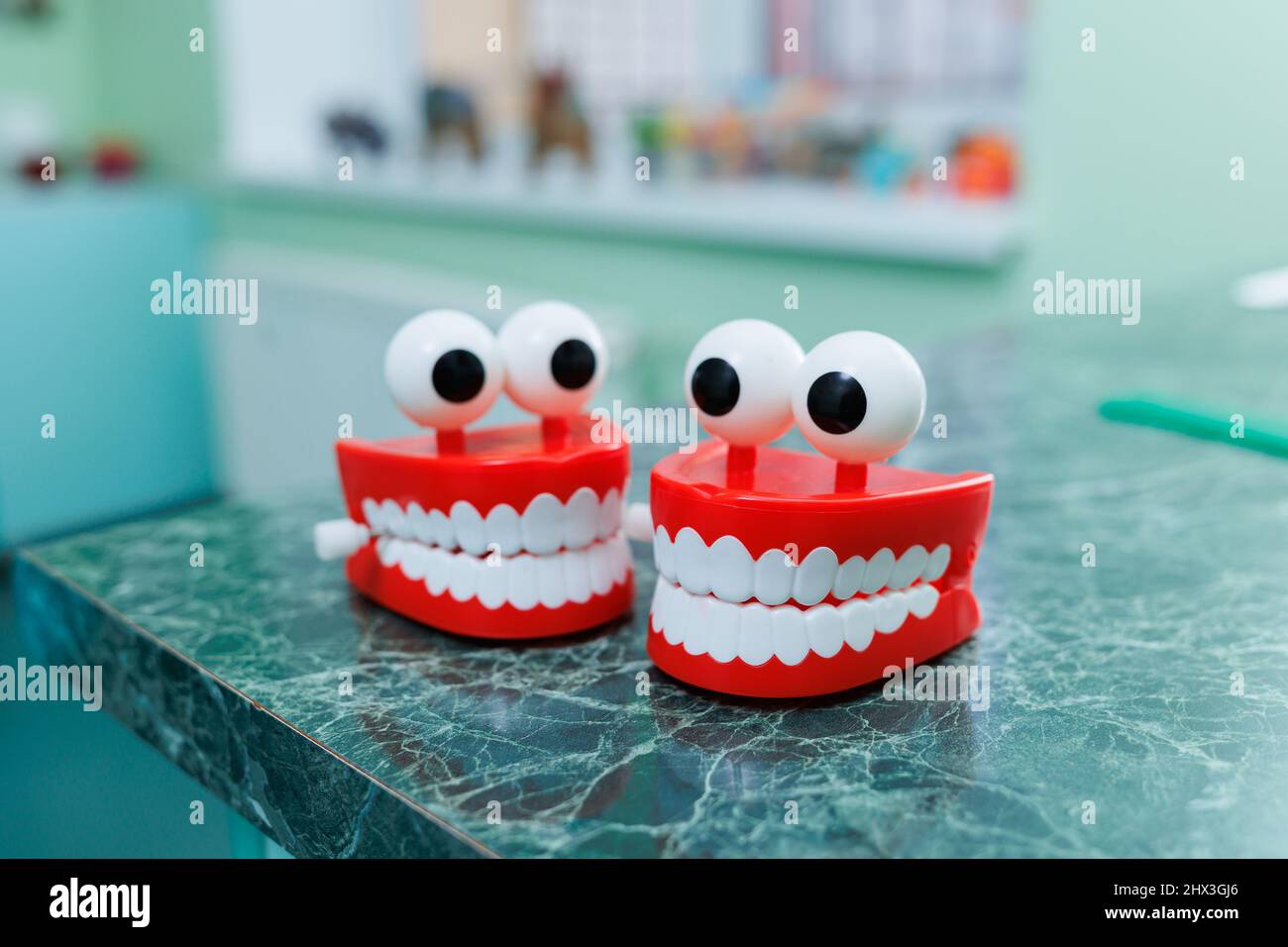Miniatures of dental artificial jaws with eyes. A plastic model of ...