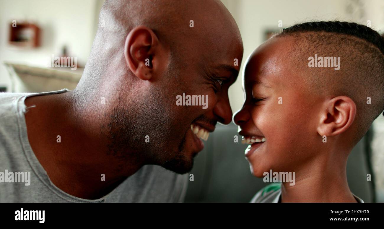 Father and boy bonding together. African dad making child laugh, face ...