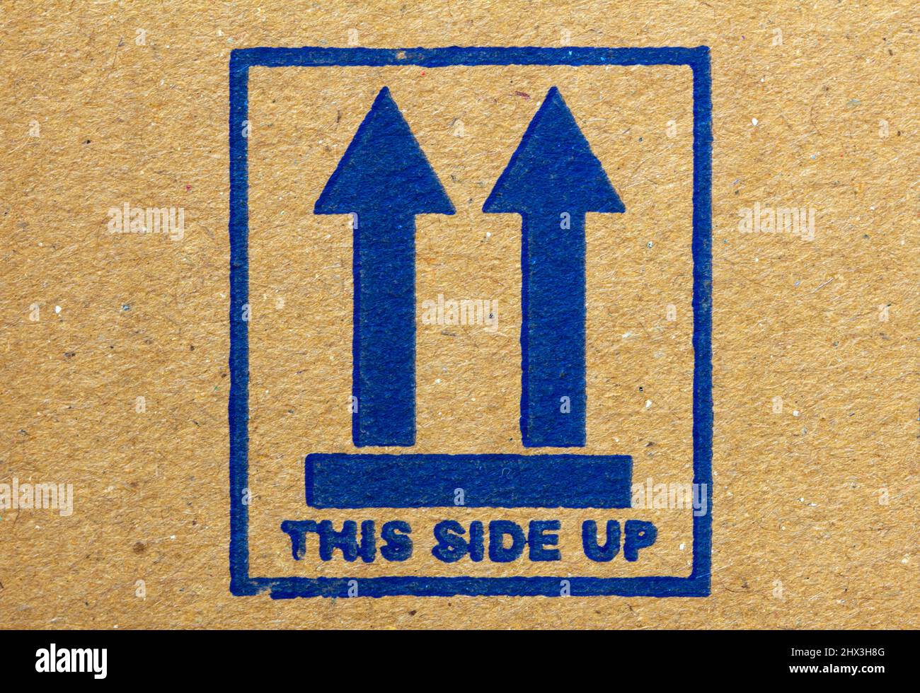 This Side Up sign in a packaging box. Arrow mark indicating correct way ...