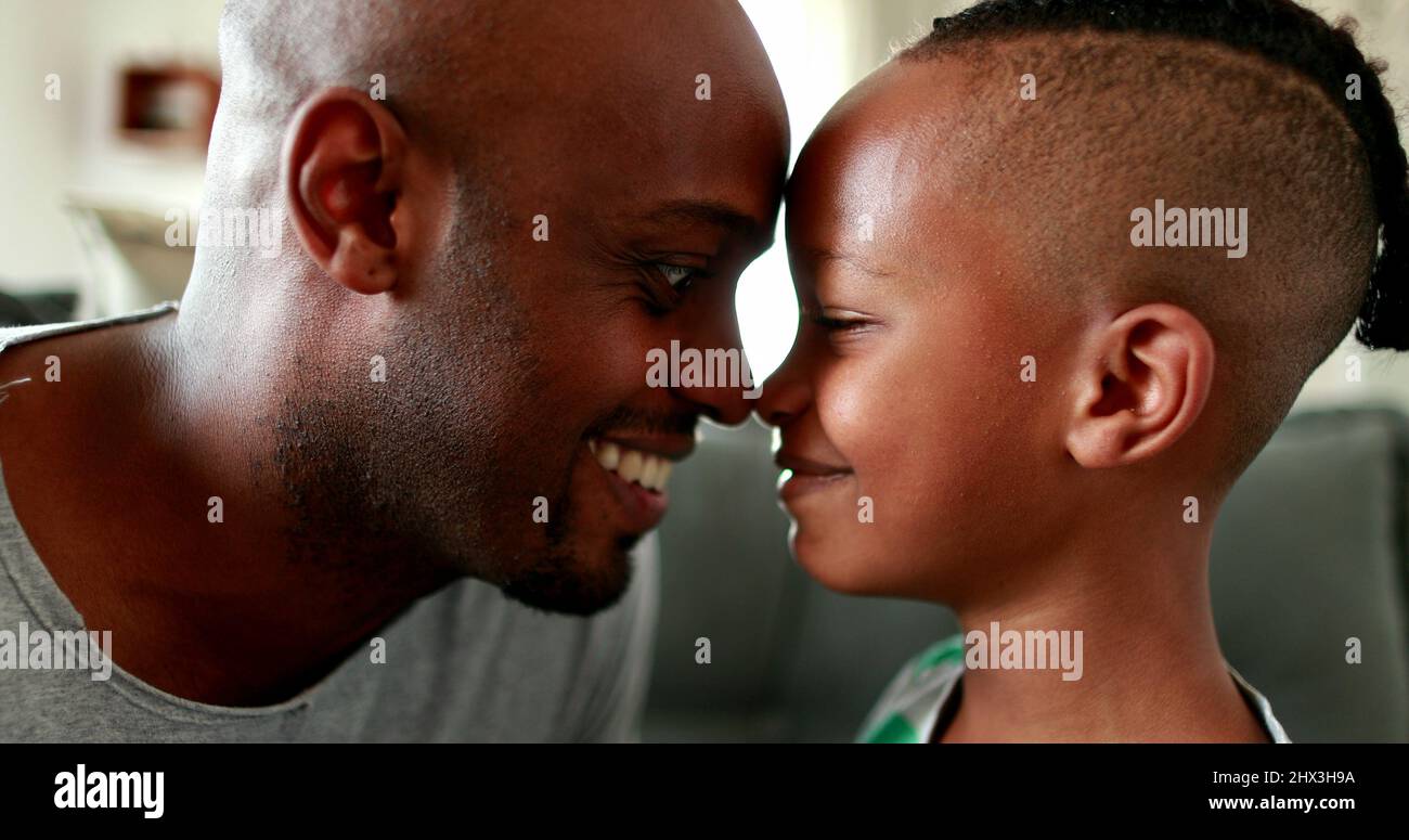 Father and boy bonding together. African dad making child laugh, face ...