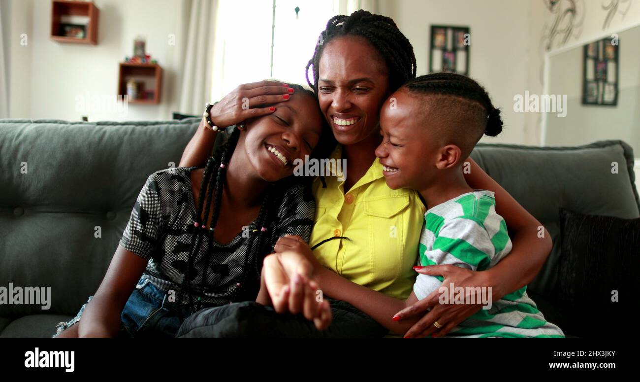 Mother and hugging with children at home, African mixed race family ...
