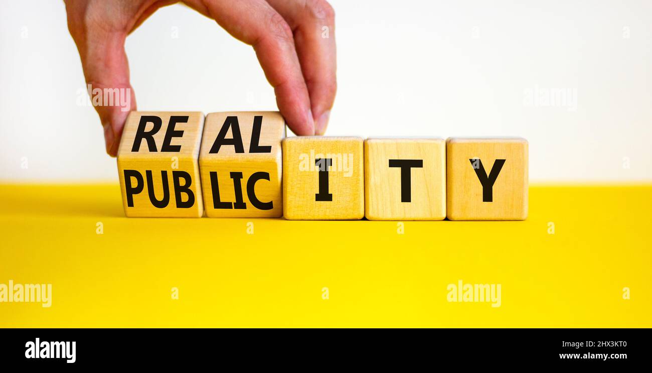 Reality or publicity symbol. Businessman turns wooden cubes and changes ...