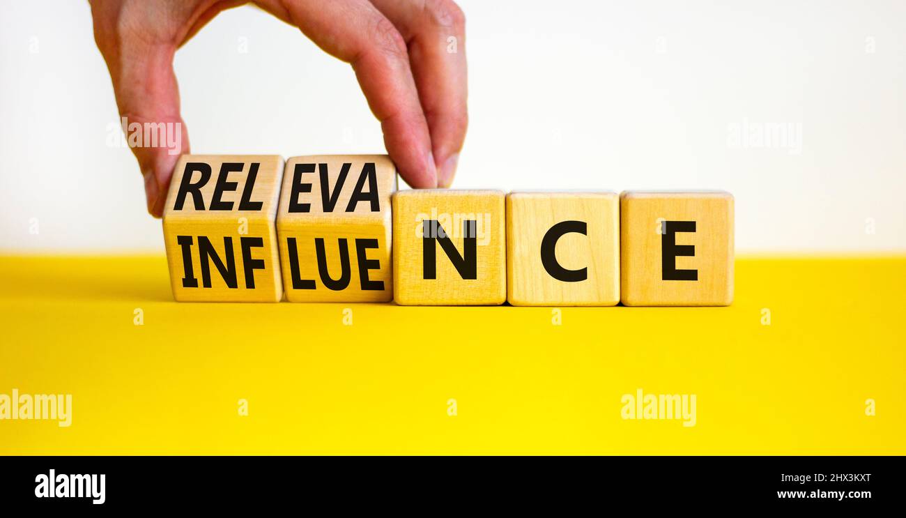 Influence or relevance symbol. Businessman turns wooden cubes and ...