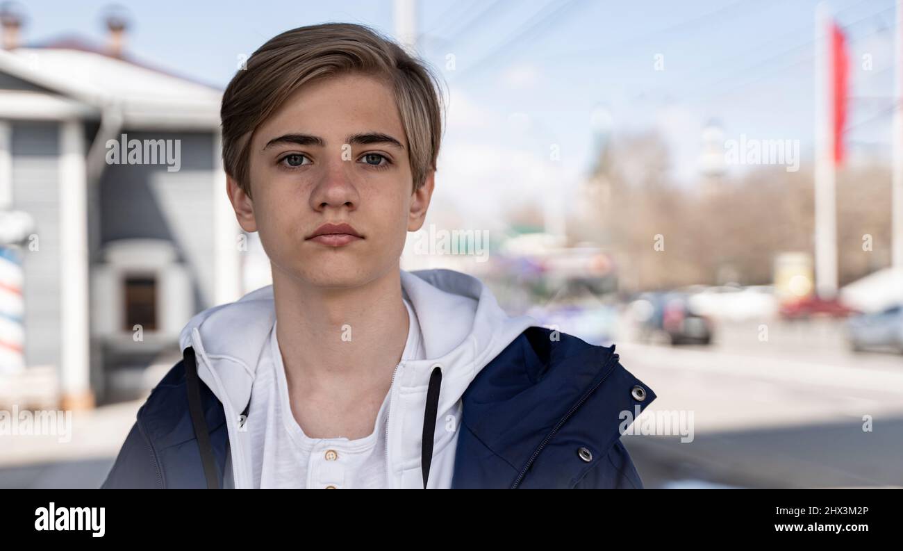 Portrait of a teenager. Teenage boy in blue jacket and white t-shirt ...