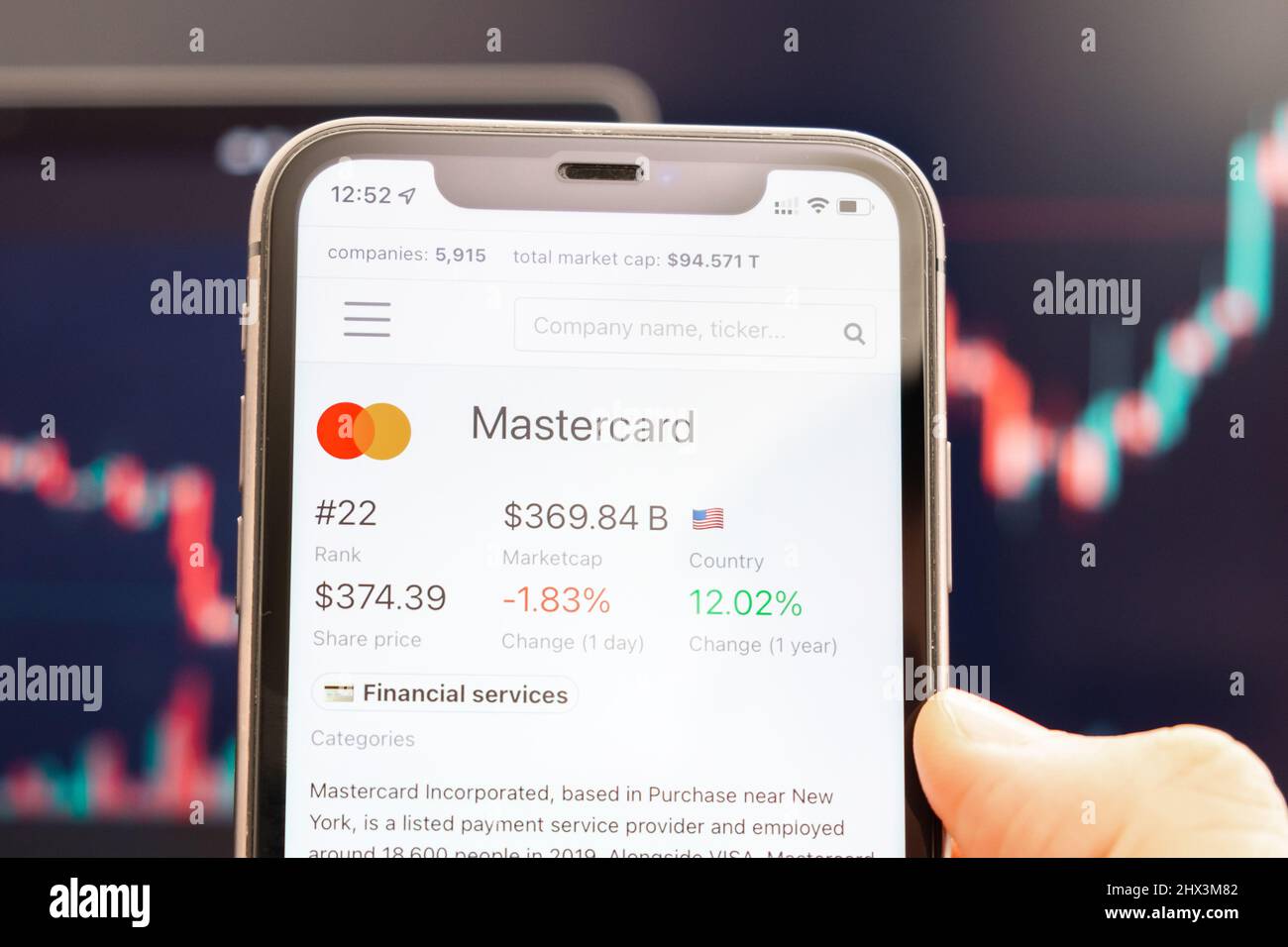 Mastercard logo of stock price on the screen of smartphone in mans hand ...