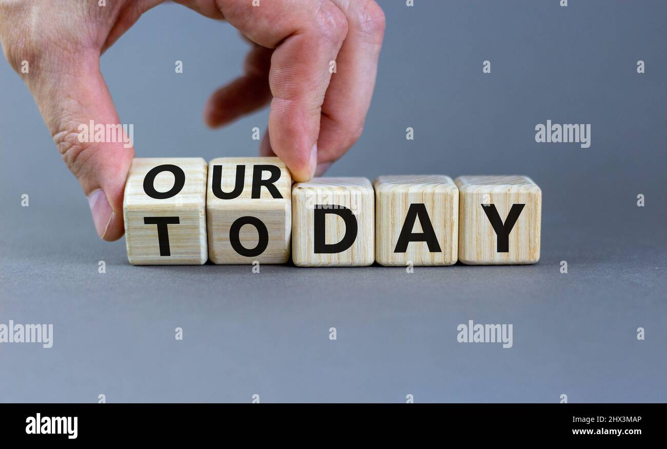 Today is our day symbol. Businessman turns wooden cubes and changes ...