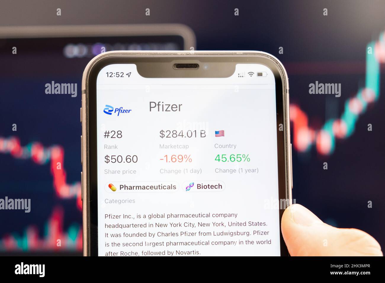 Pfizer stock price on the screen of mobile phone in mans hand with ...