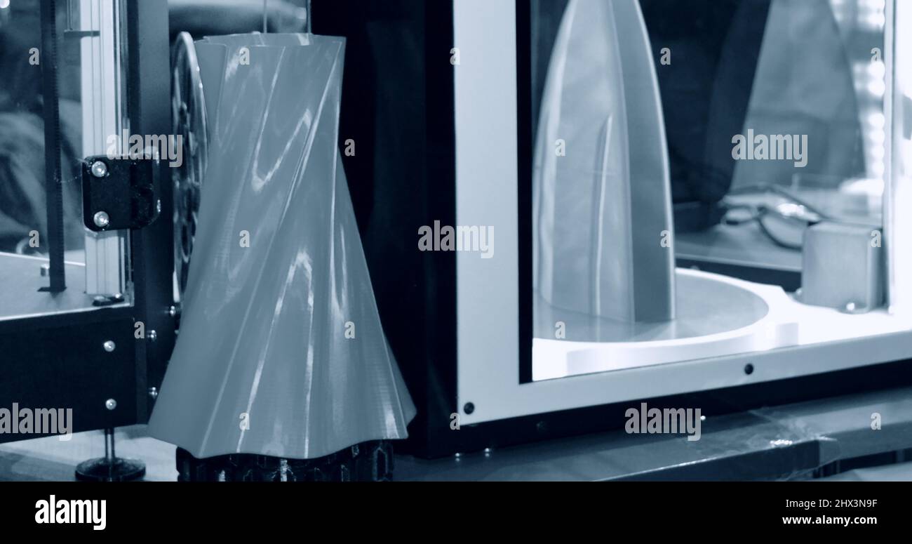 3D printer works and creates an object from the hot molten plastic ...