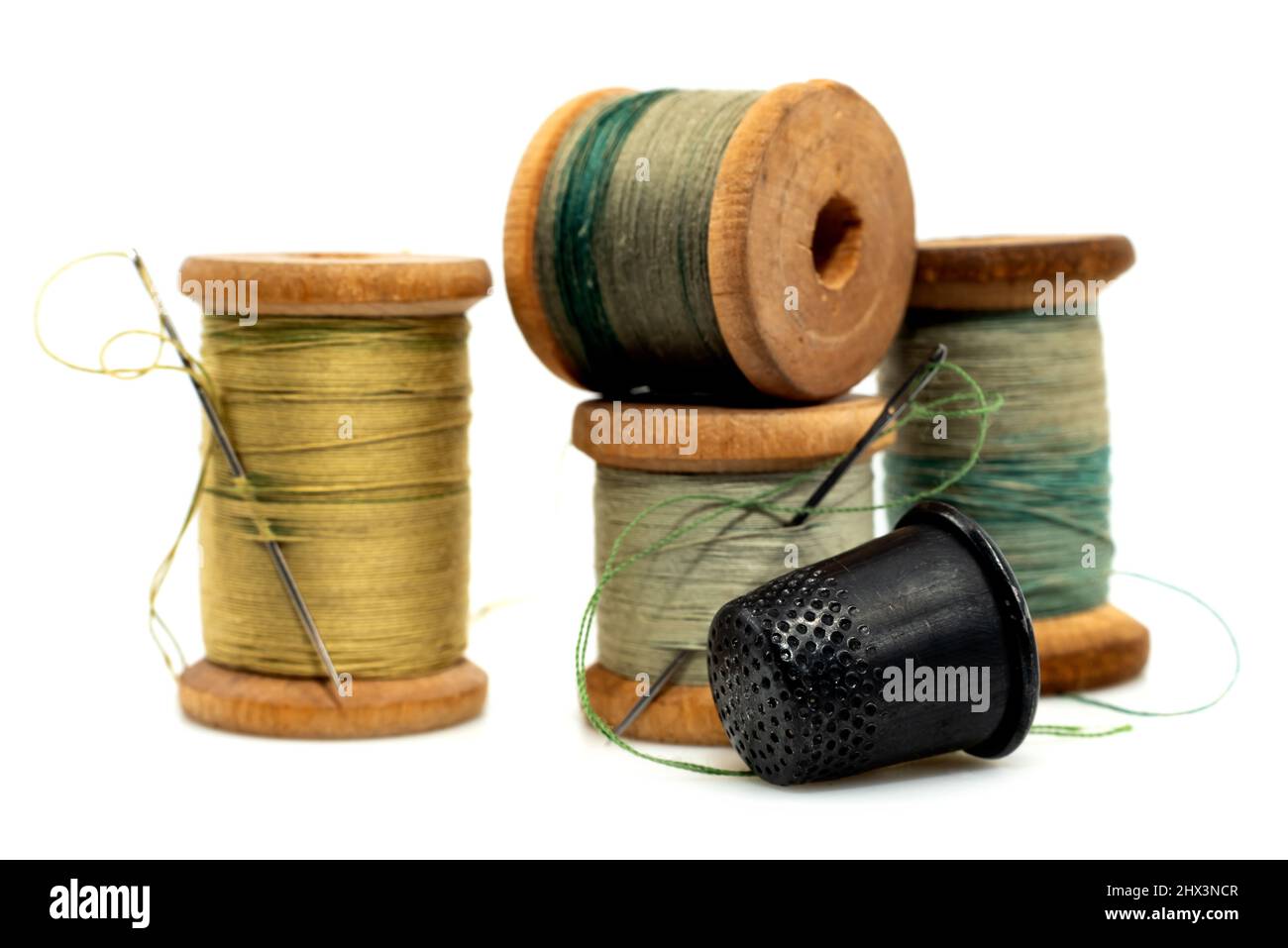 Vintage retro spool of thread on a white background. Needle with thread ...