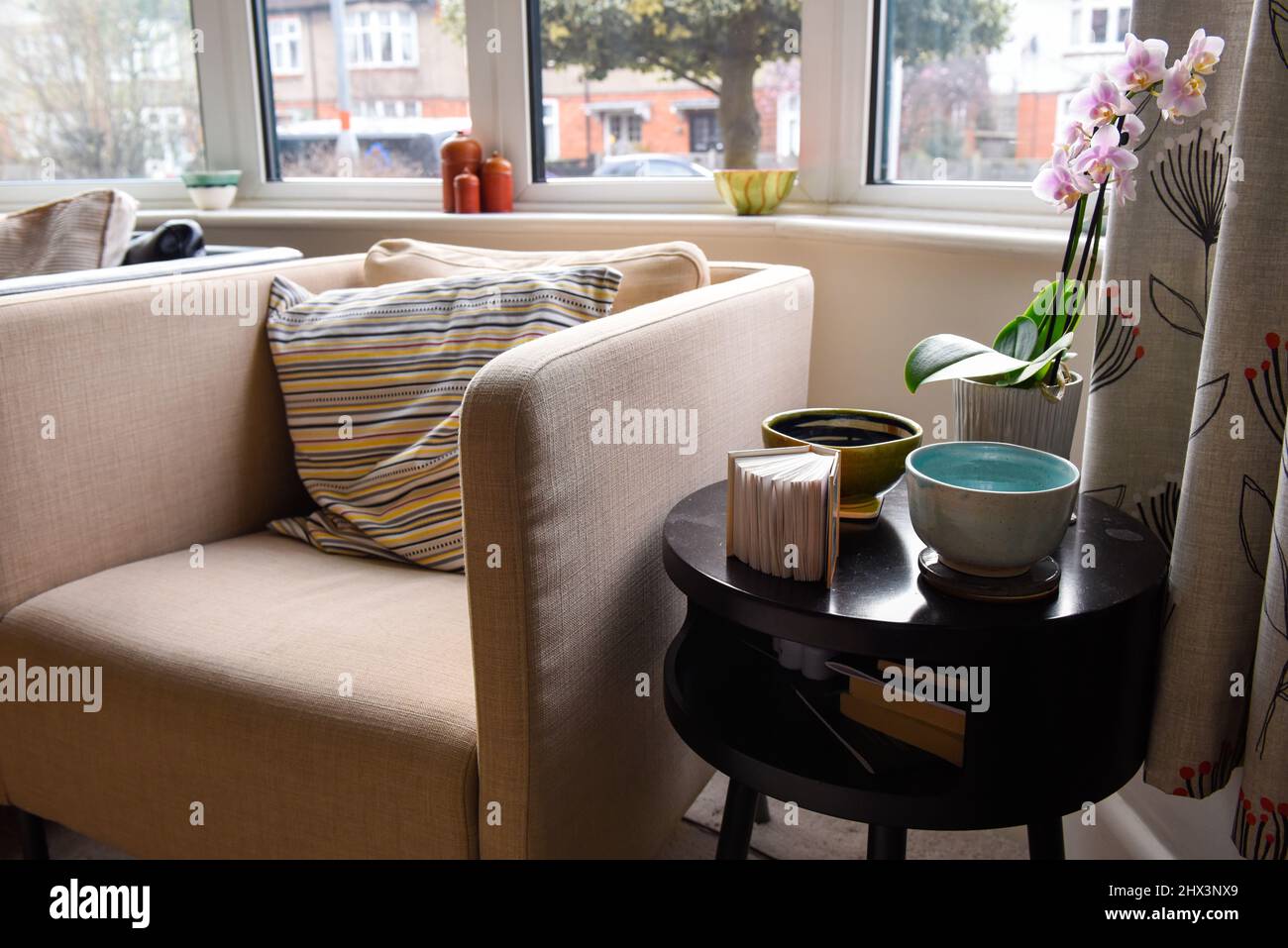 Stylish home interior with seating and view through window Stock Photo ...