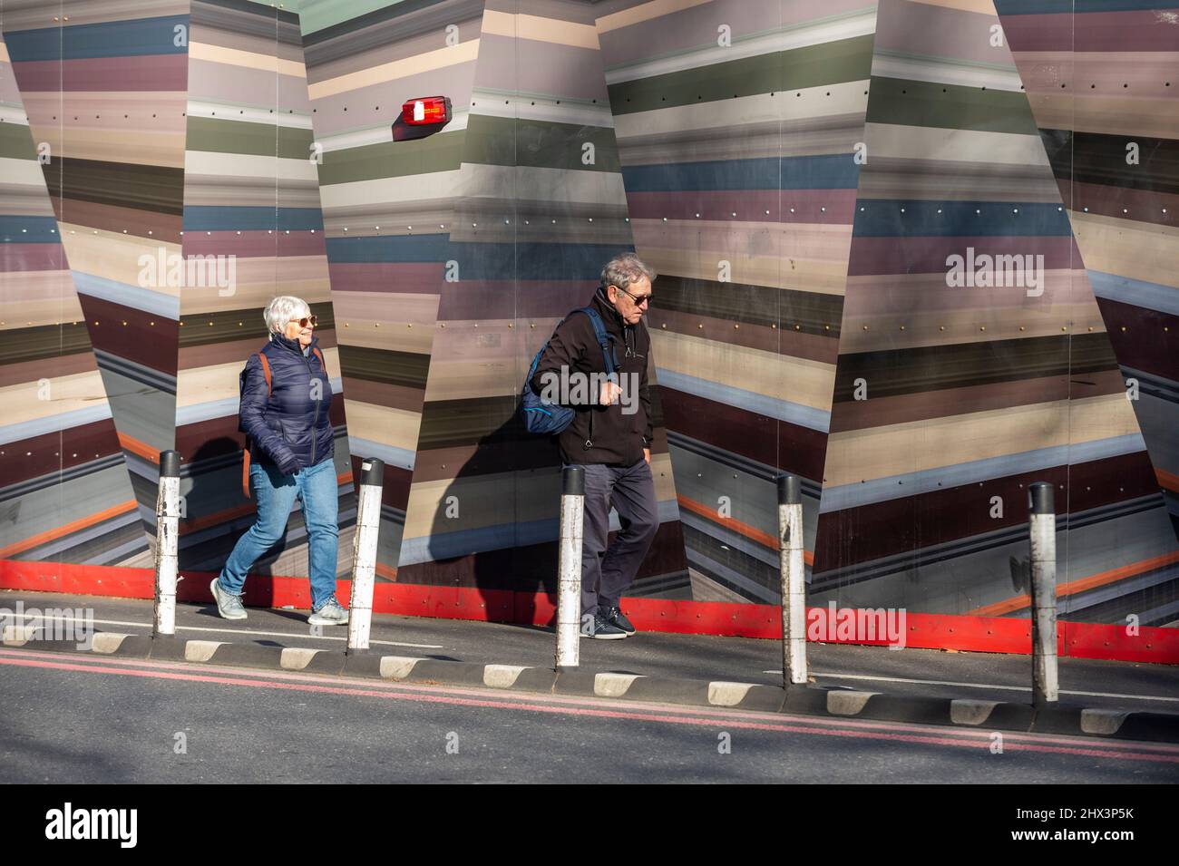 London, UK. 9 March 2022. A couple passes between the two 25m long ...