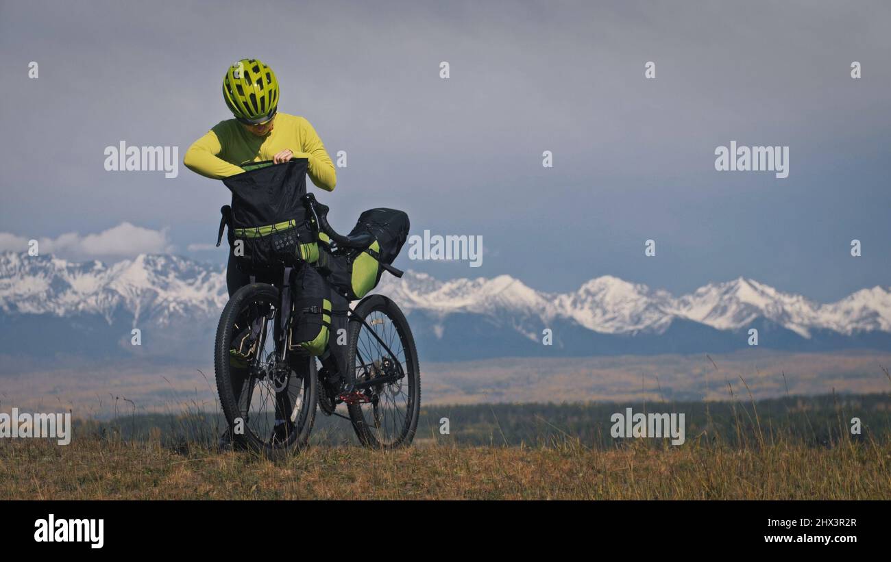The woman travel on mixed terrain cycle touring with bikepacking. The ...