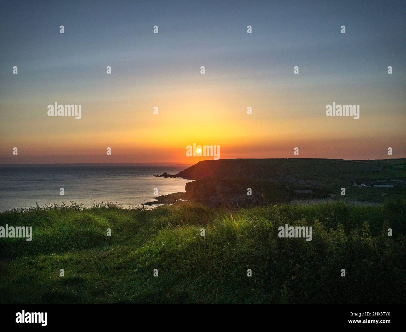 Sunset off the cornish coast Stock Photo - Alamy