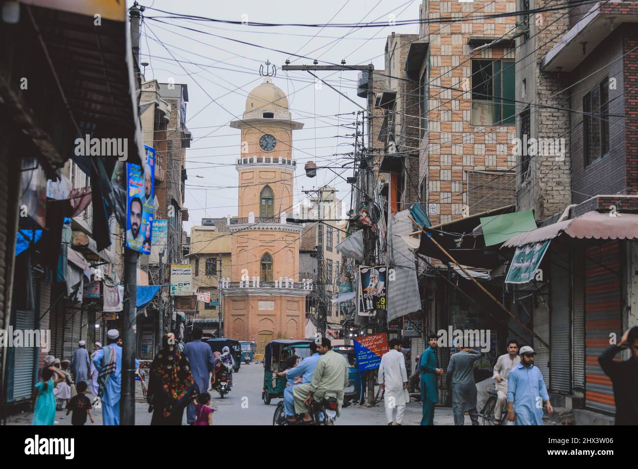Daily life of the crowded Peshawar city center with the Buildings and ...
