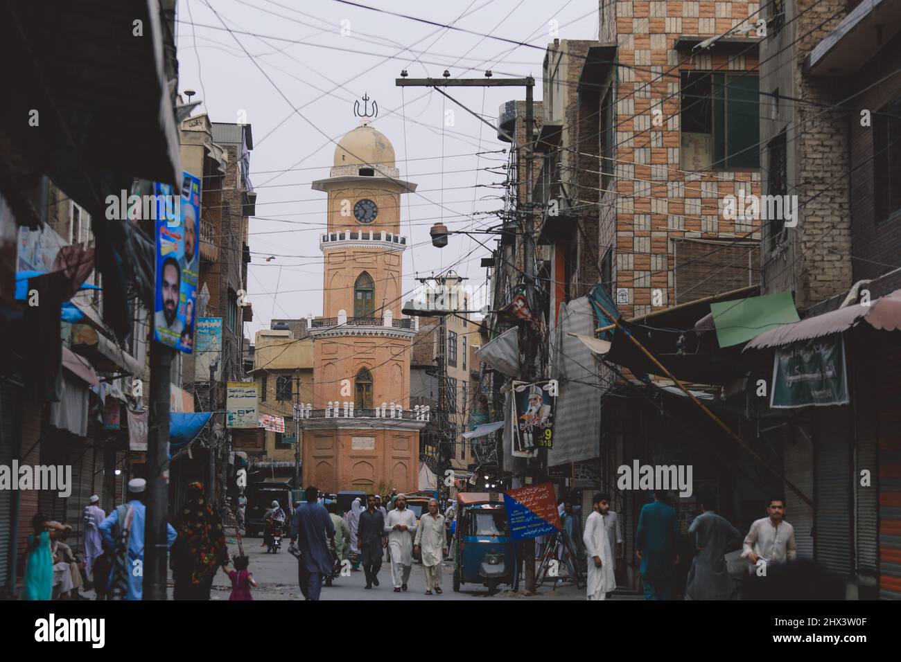 Daily life of the crowded Peshawar city center with the Buildings and ...