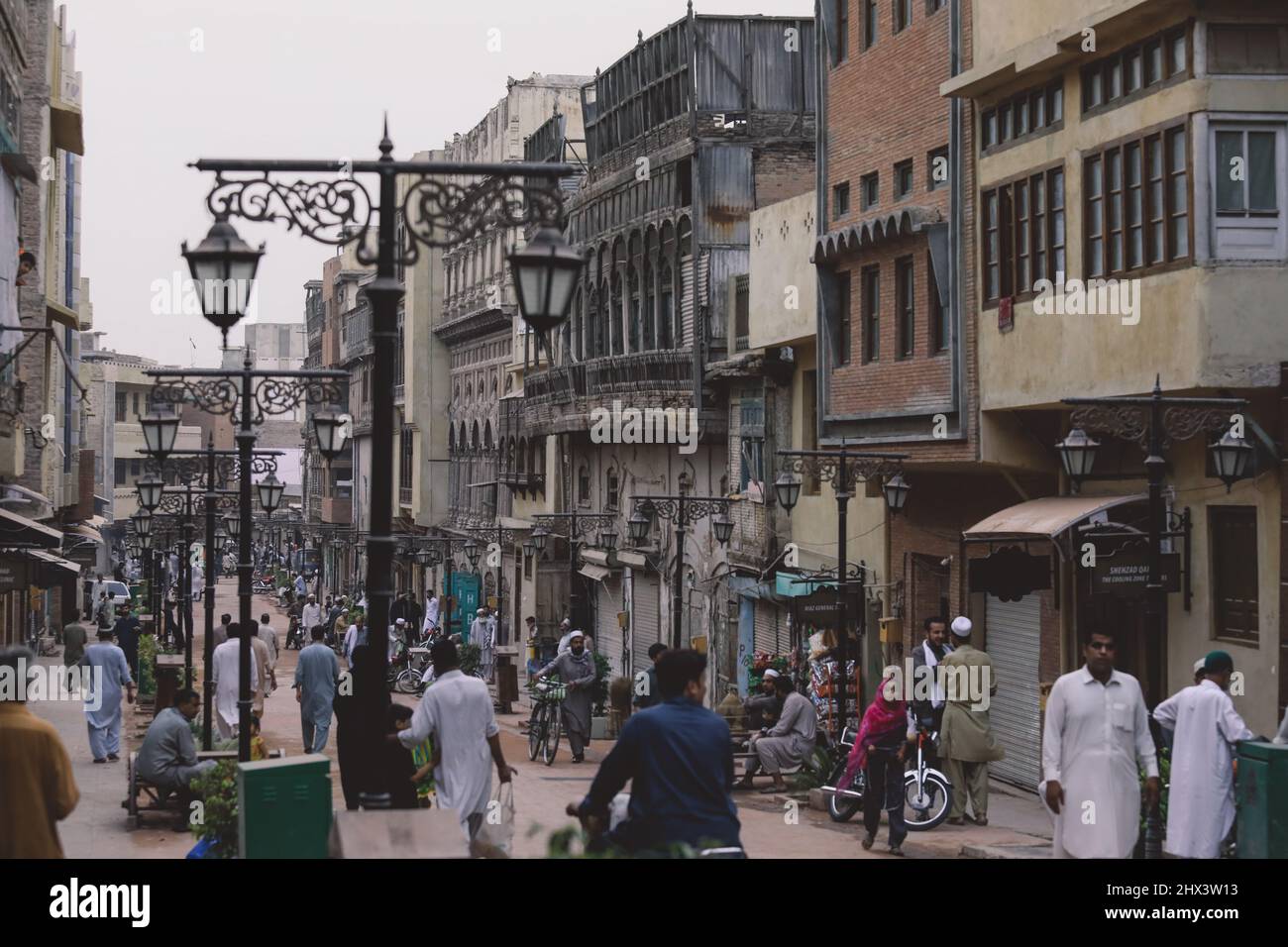 Daily life of the crowded Peshawar city center with the Buildings and ...