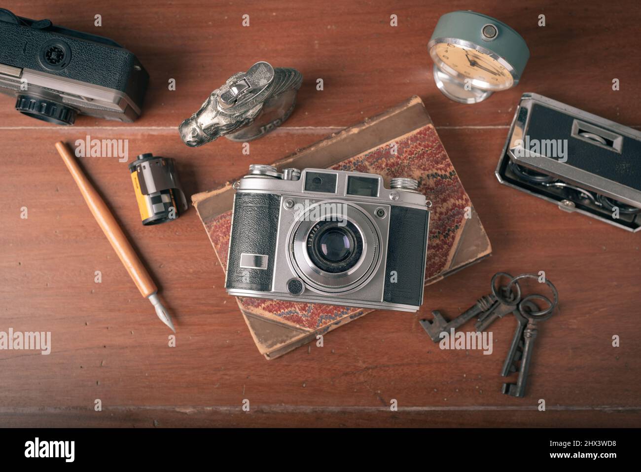 Old film camera on wooden desktop Stock Photo - Alamy
