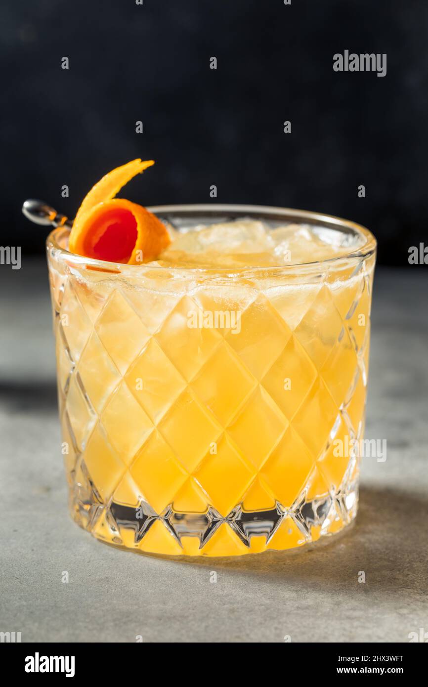 Cold Boozy Rye Whiskey Sour with Lemon and a Garnish Stock Photo - Alamy