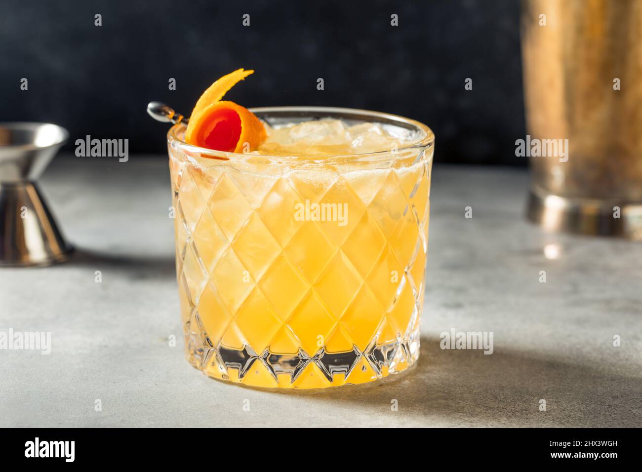 Cold Boozy Rye Whiskey Sour with Lemon and a Garnish Stock Photo - Alamy