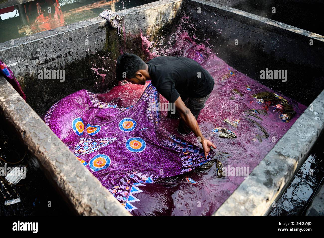 A worker working at a dye factory.The small-scale textile dyeing operators in Bangladesh process ...