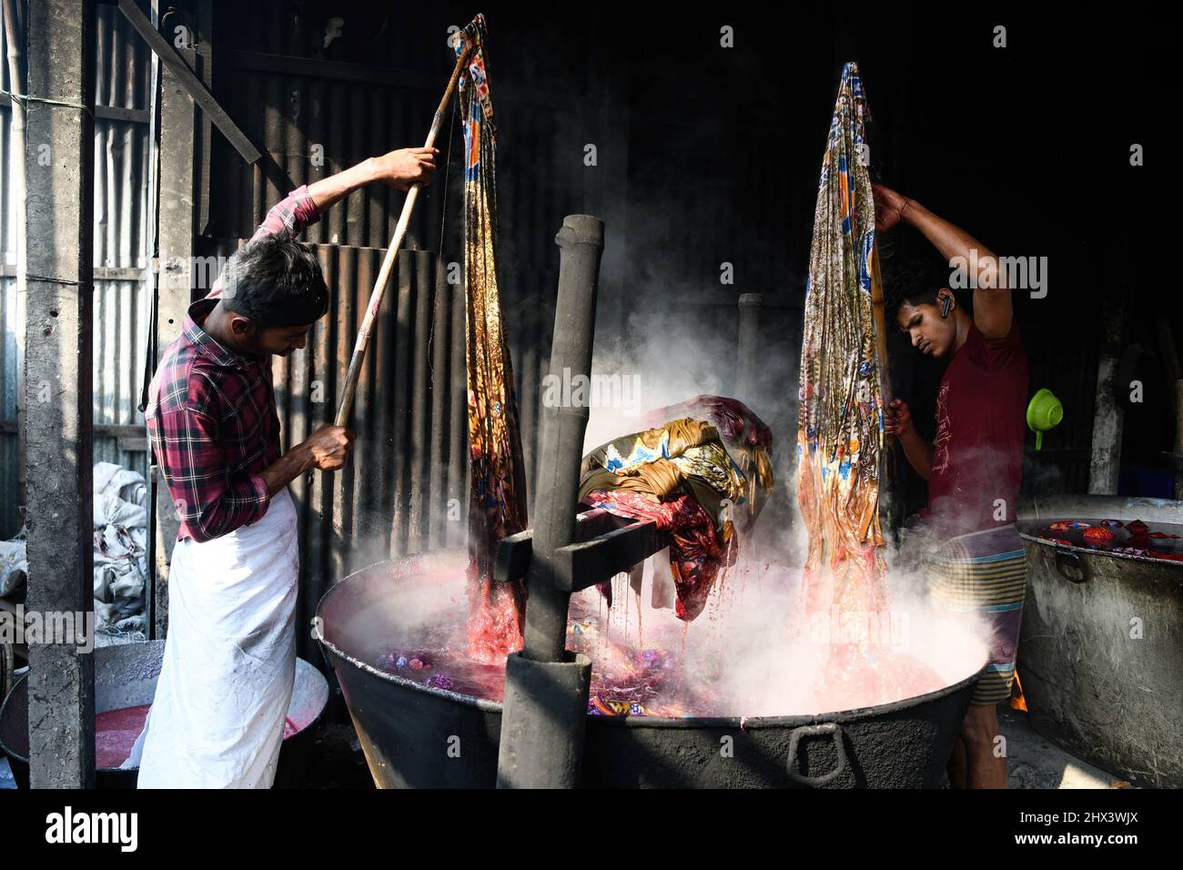 Workers working at a dye factory.The small-scale textile dyeing ...
