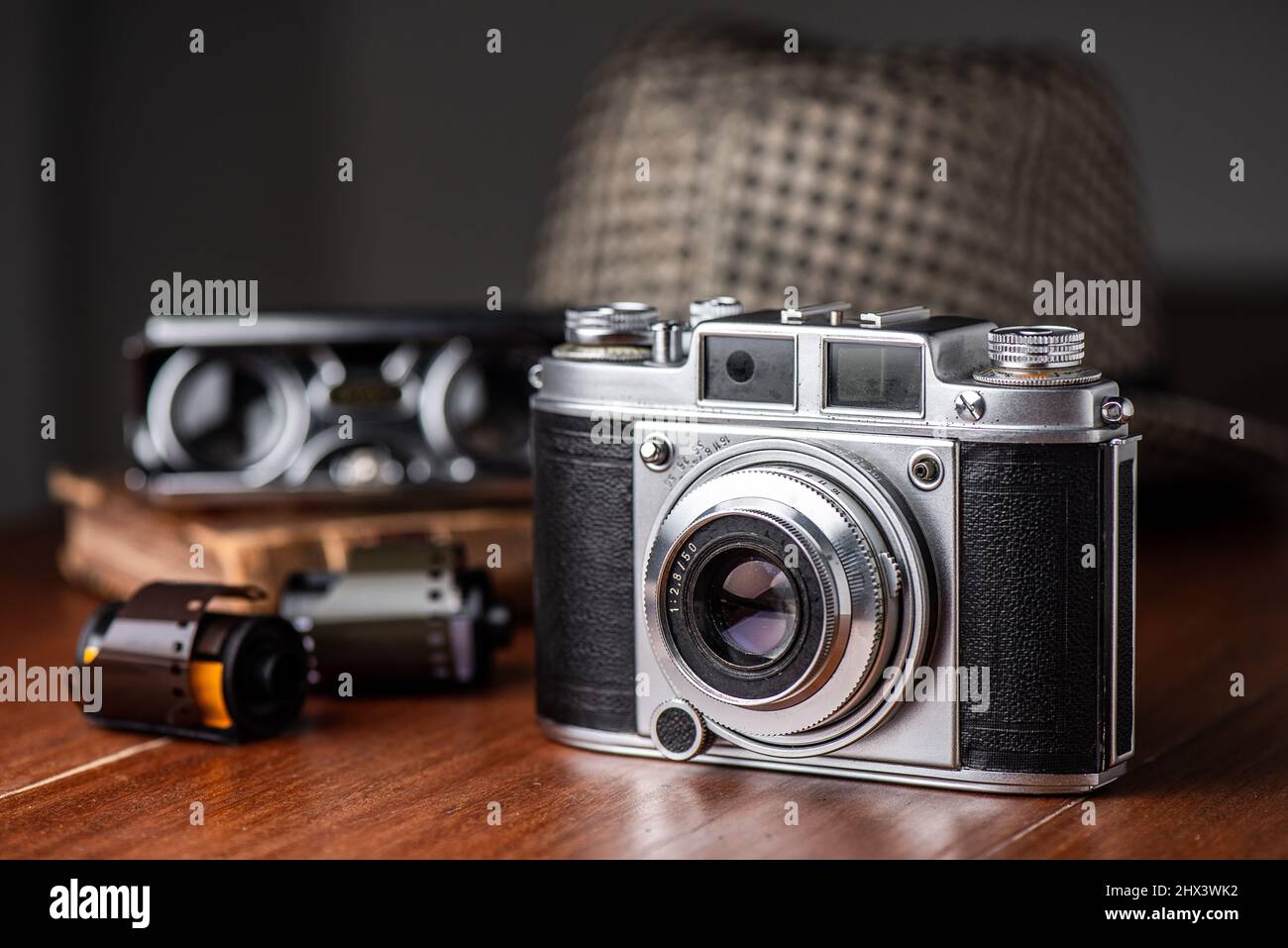 Old film camera on wooden desktop Stock Photo - Alamy