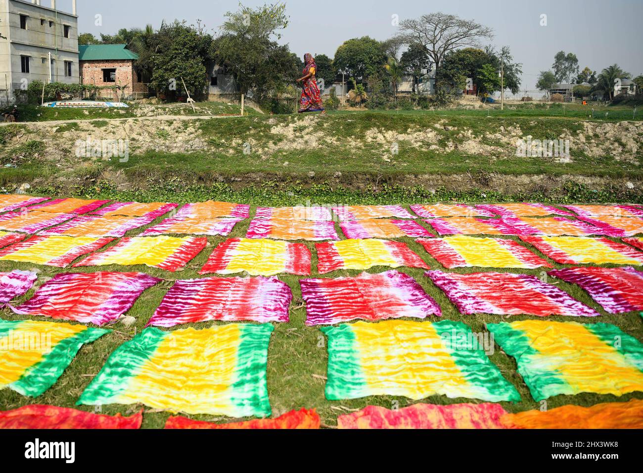 A pedestrian walks past a dye factory in the Narayanganj district near ...